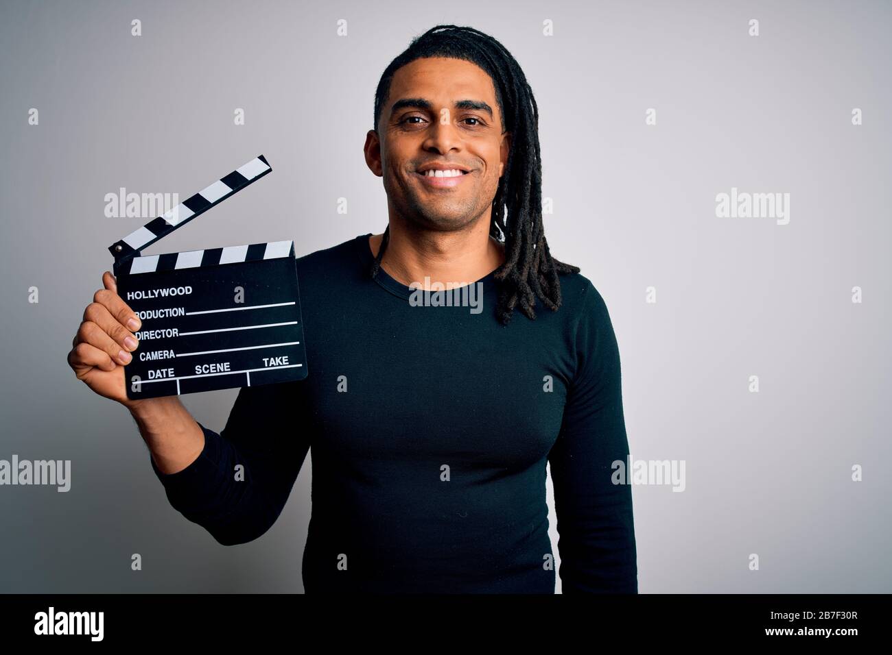 Young african american afro director man making movie using clapboard ...