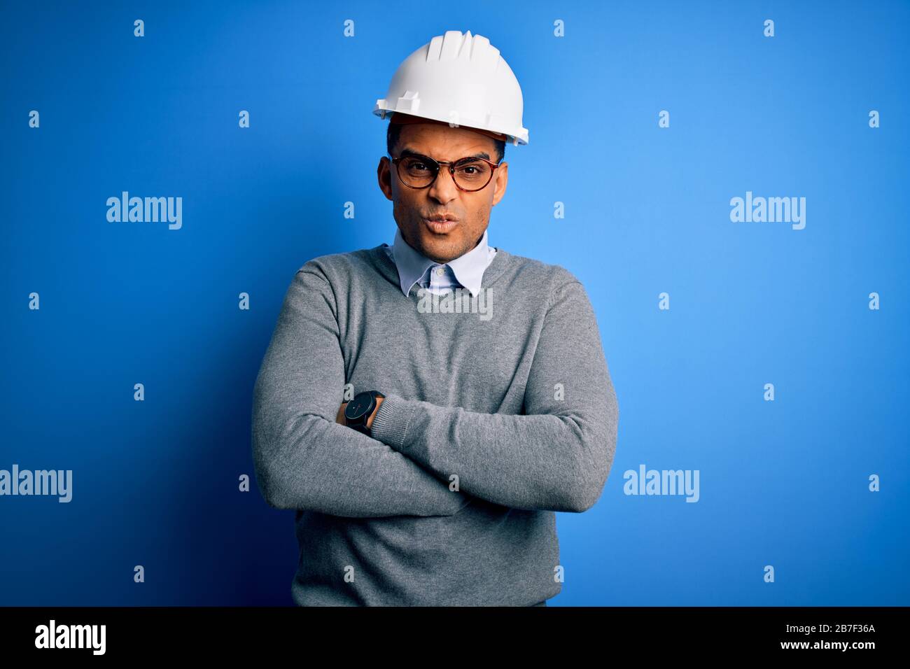 Young handsome african american engineer man with dreadlocks wearing ...