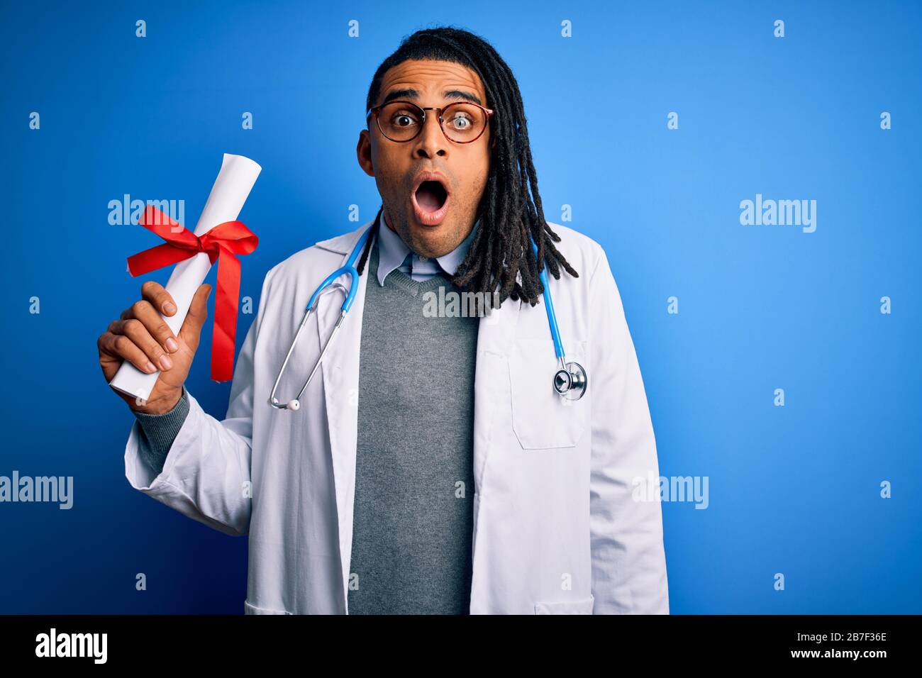 African american doctor man with dreadlocks wearing stethoscope holding ...