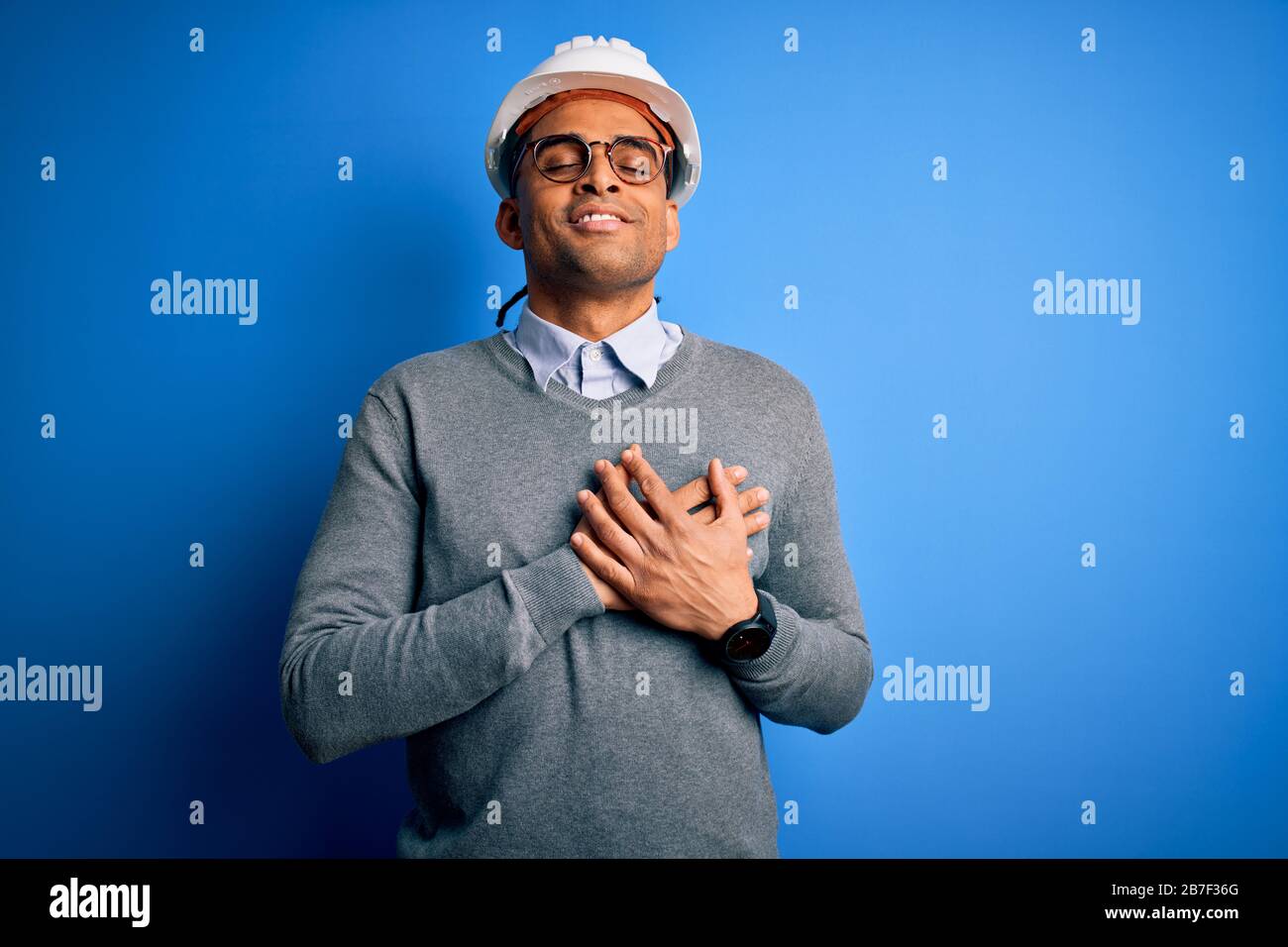 Young handsome african american engineer man with dreadlocks wearing ...
