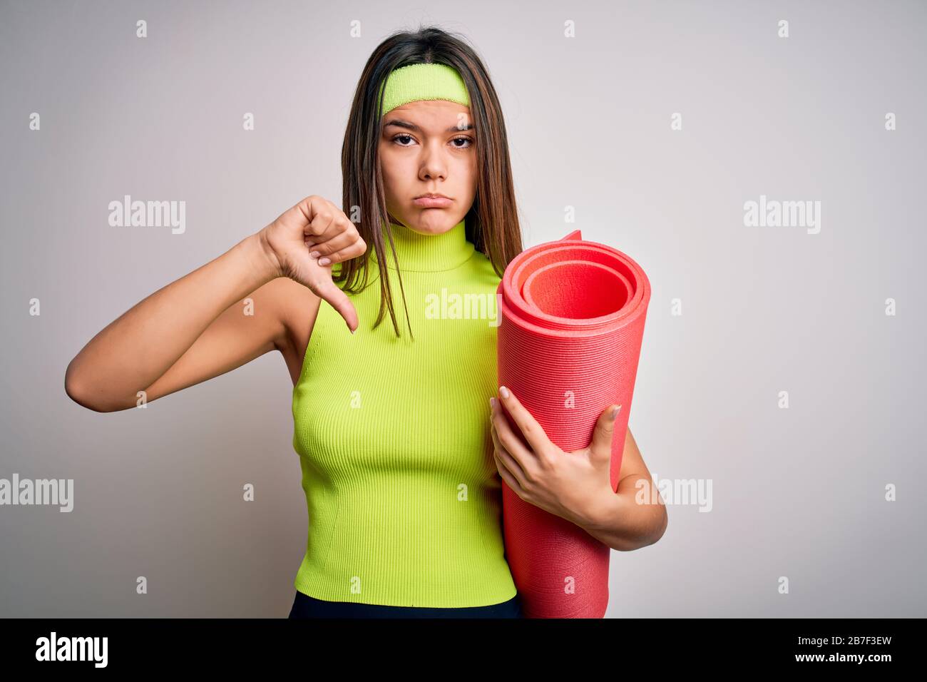 Beautiful sporty girl doing sport wearing sportswear holding yoga mat ...