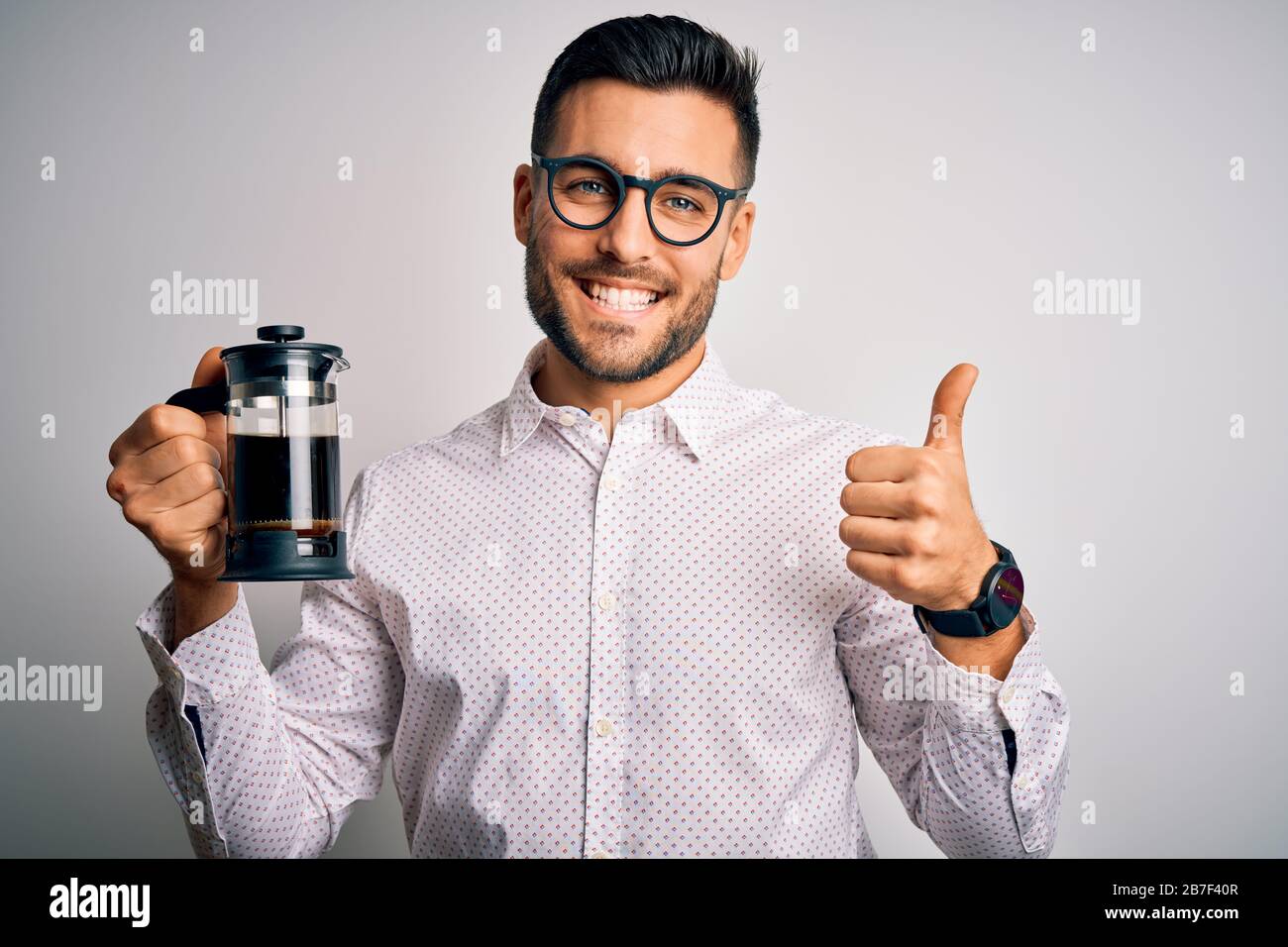 Young handsome man making coffee using french press coffeemaker over ...