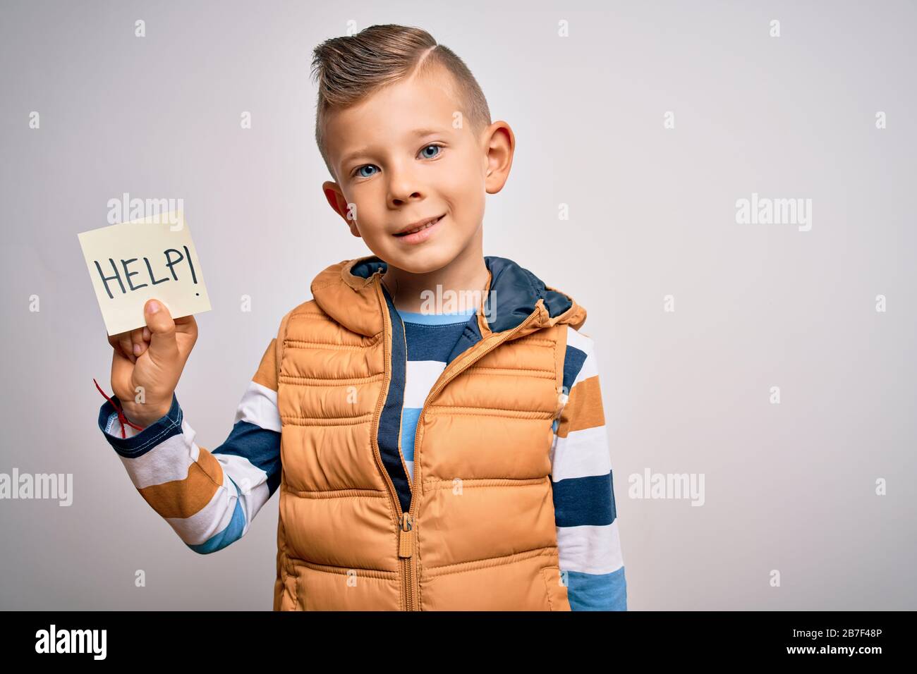 Young little caucasian kid asking for help on a paper note as violence ...
