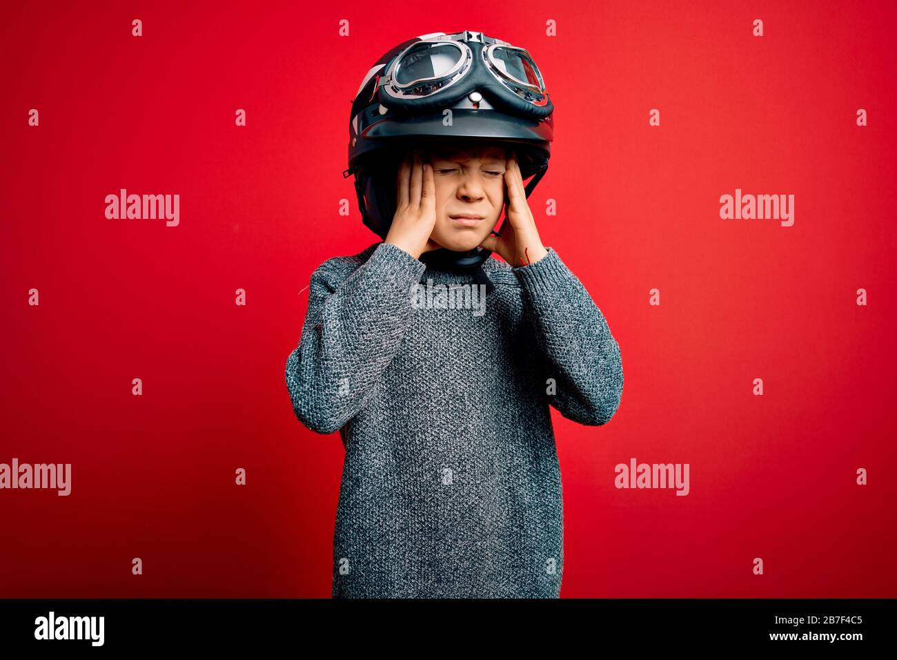 Young little caucasian kid wearing vintage biker motorcycle helmet and ...