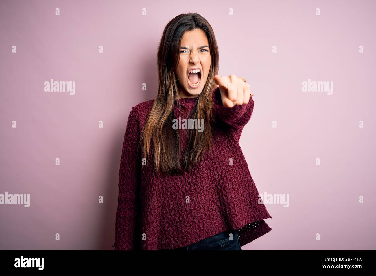 Young beautiful girl wearing casual sweater over isolated pink ...