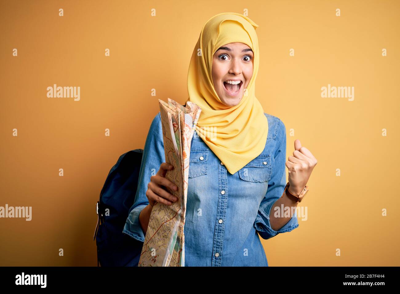 Young tourist girl on vacation wearing muslim hijab and backpack ...