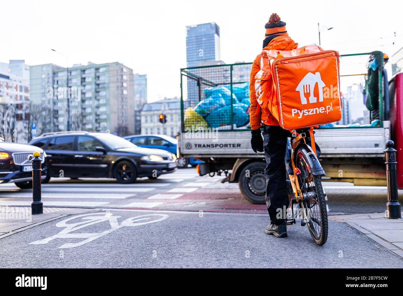 Warsaw, Poland - December 19, 2019: Pyszne.pl courier glover in orange ...