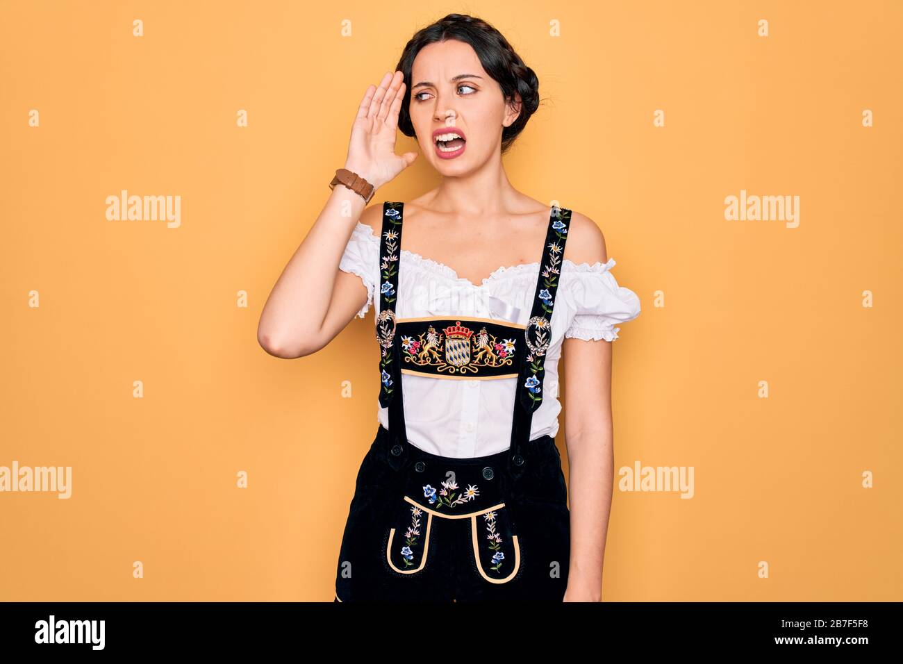 Young beautiful german woman with blue eyes wearing traditional ...