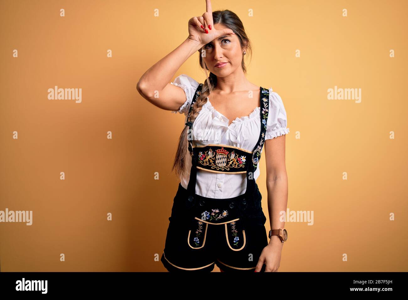 Young beautiful brunette german woman celebrating Octoberfest wearing ...