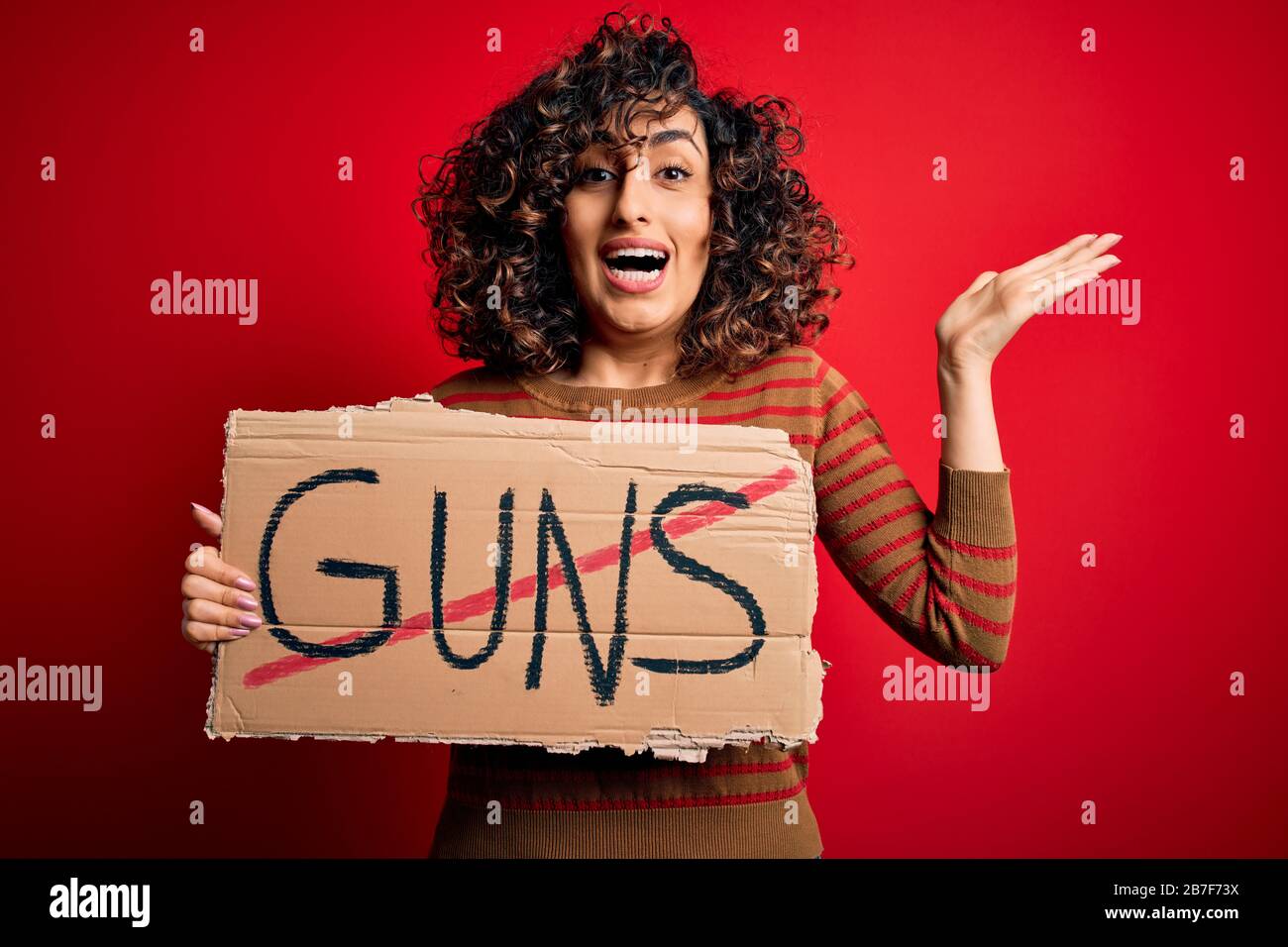 Young beautiful arab woman asking for peace holding banner with ...