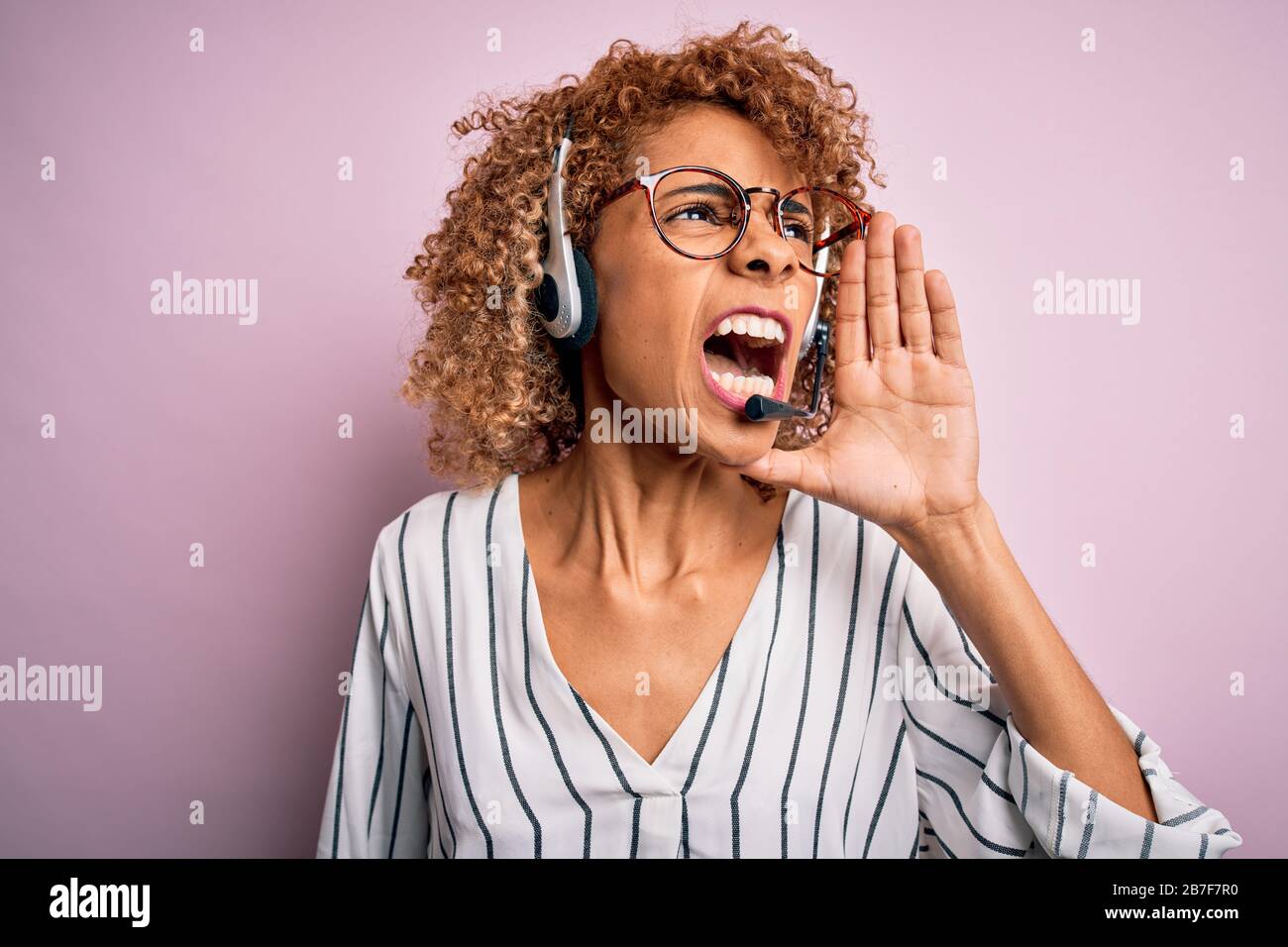 African american curly call center agent woman working using headset ...