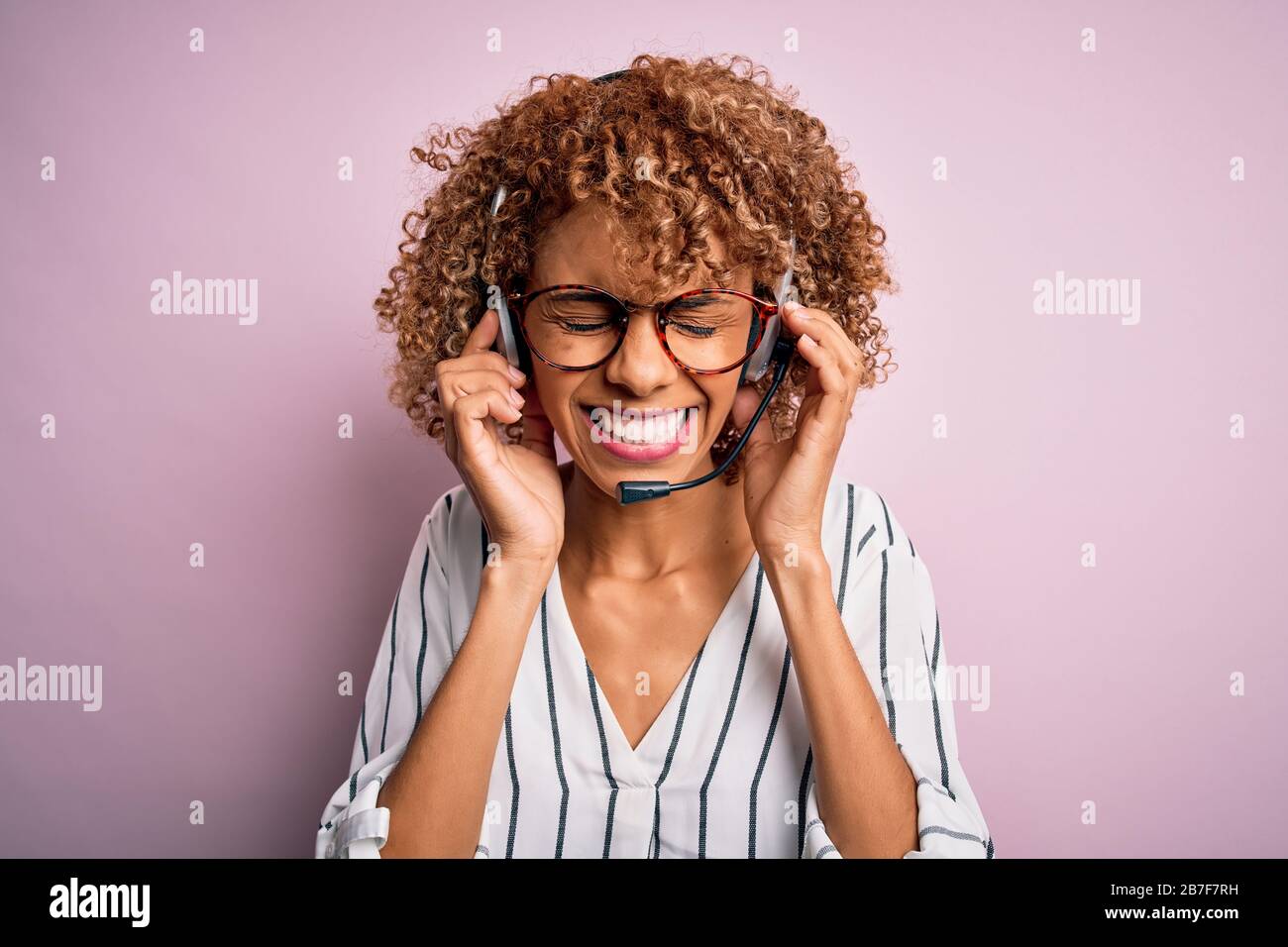 African american curly call center agent woman working using headset ...