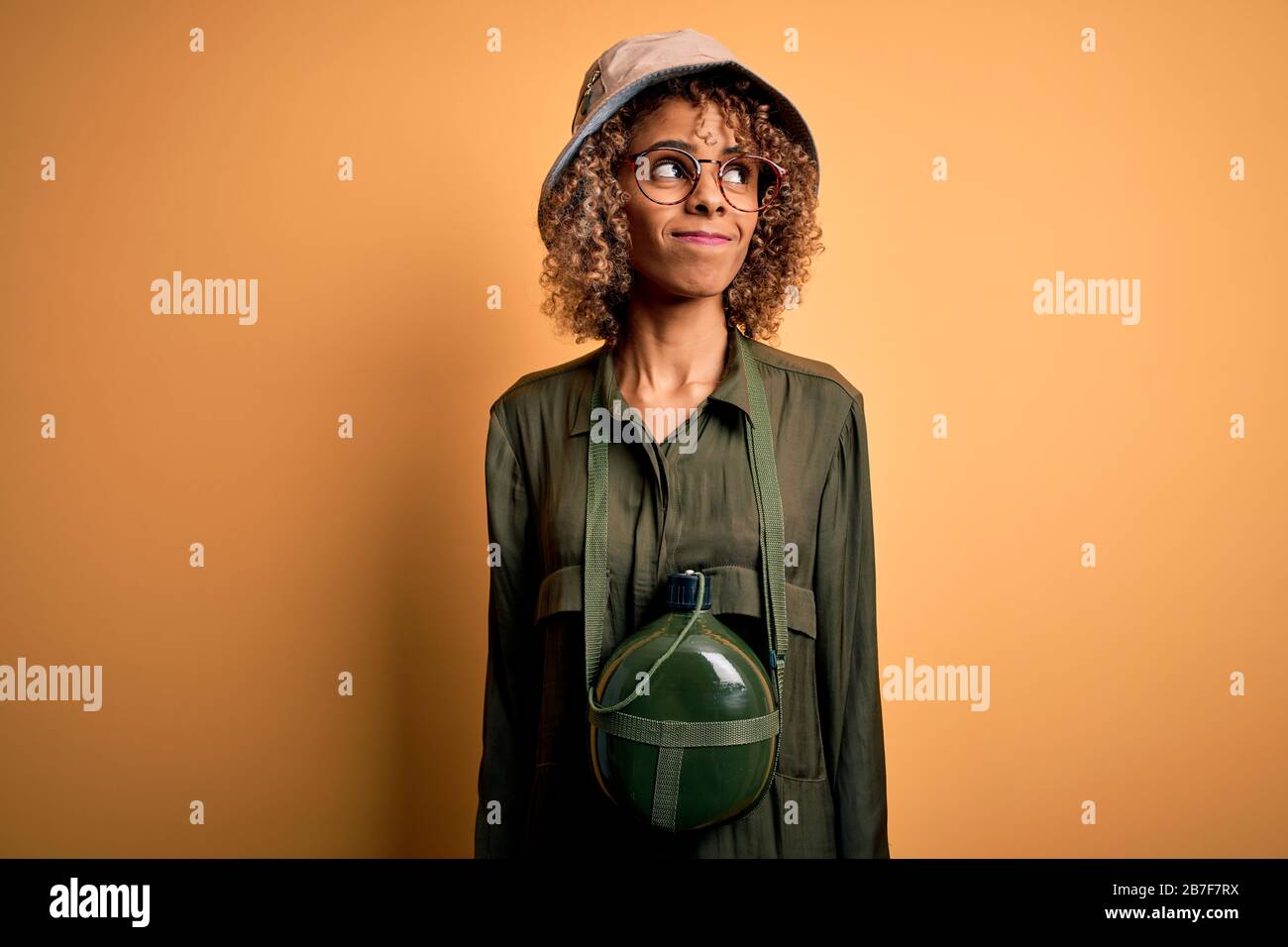 Young african american tourist woman on vacation wearing explorer hat ...