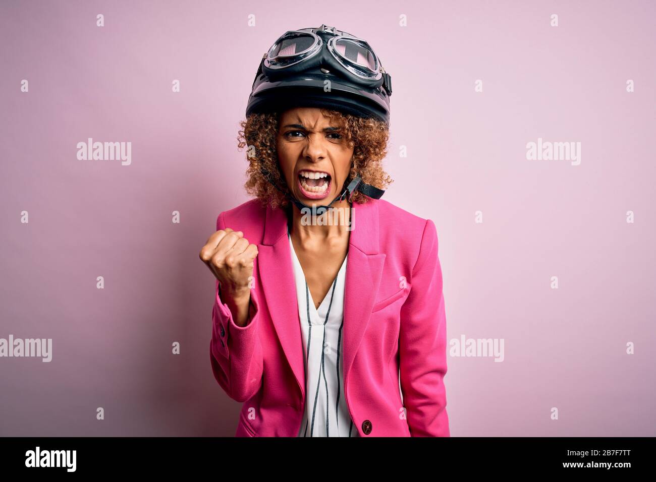 African american motorcyclist woman with curly hair wearing moto helmet ...