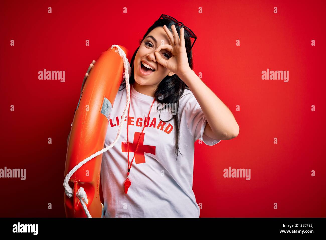 Young lifeguard woman wearing secury guard equipent holding rescue ...