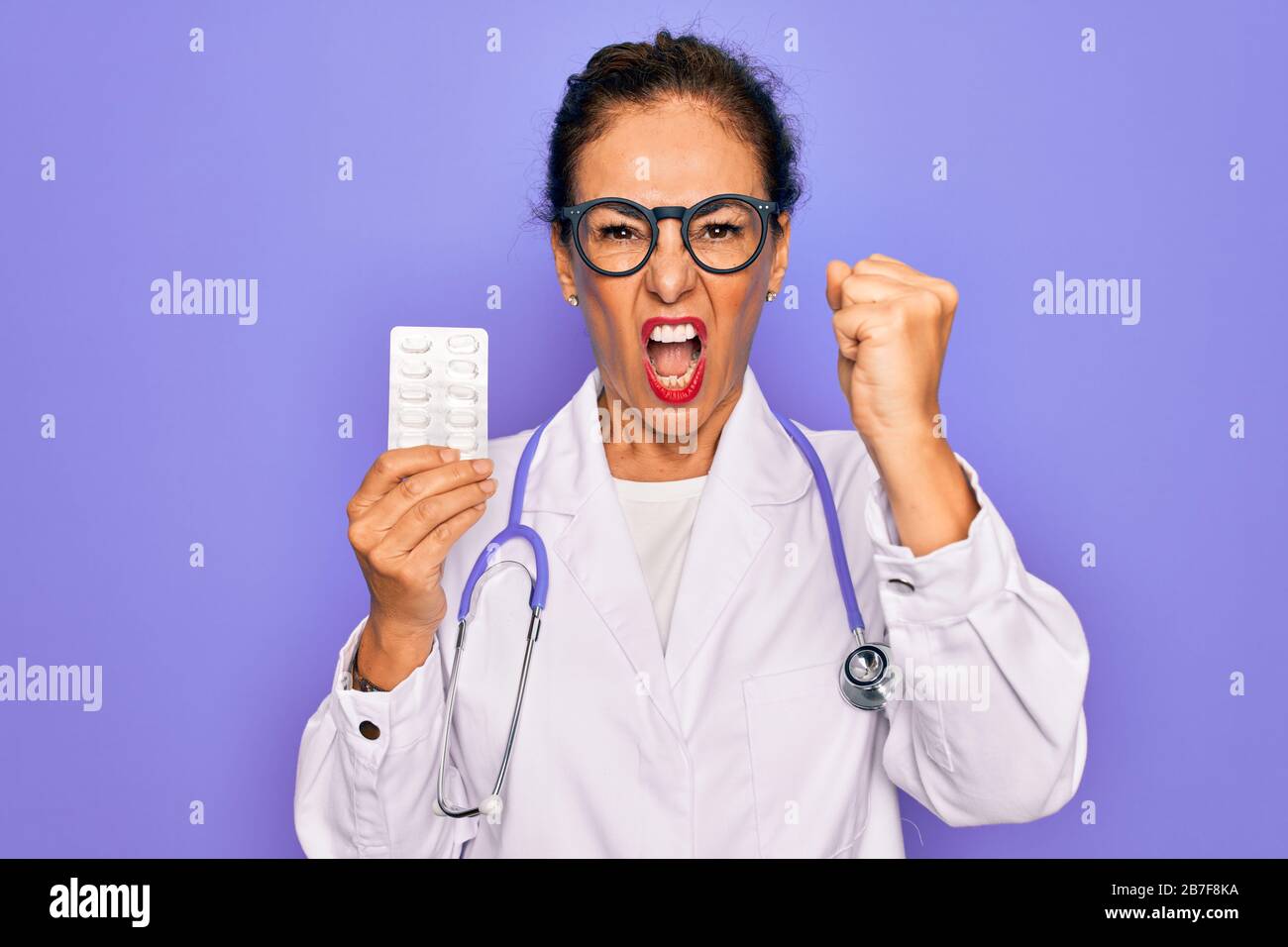 Middle age senior professional doctor woman holding pharmaceutical ...
