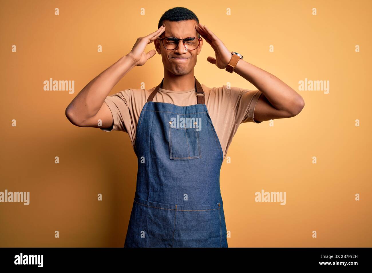 Young handsome african american shopkeeper man wearing apron over ...