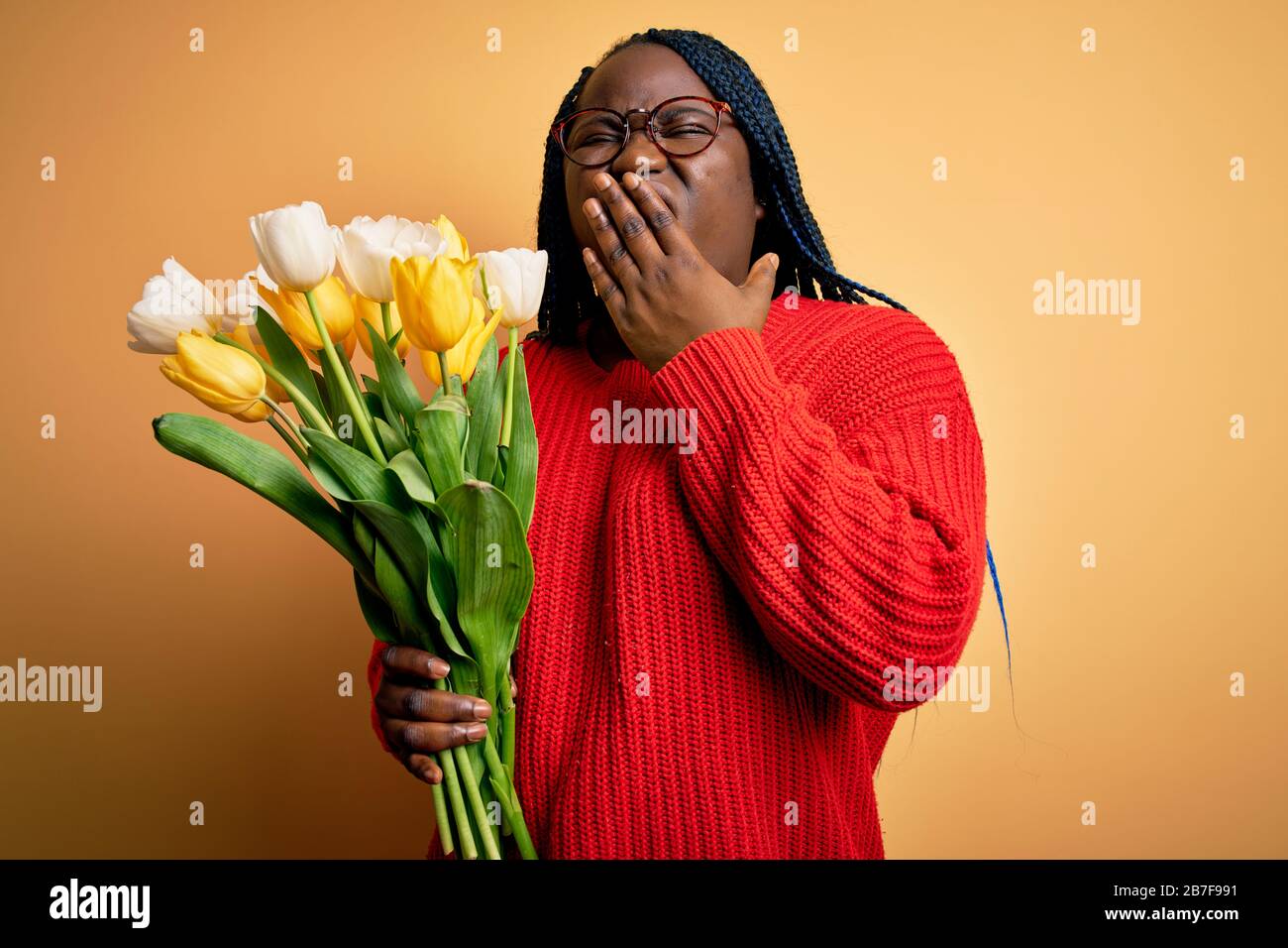 Young african american plus size woman with braids holding bouquet of ...