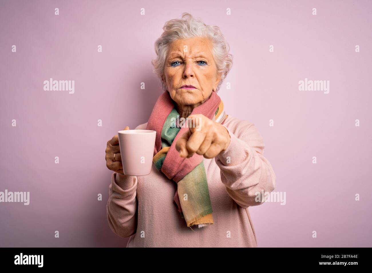 Senior beautiful grey-haired woman drinking mug of coffee over isolated ...