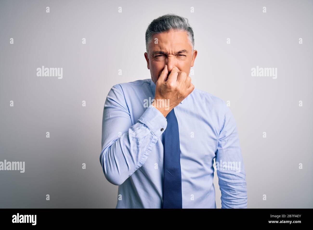 Middle age handsome grey-haired business man wearing elegant shirt and ...