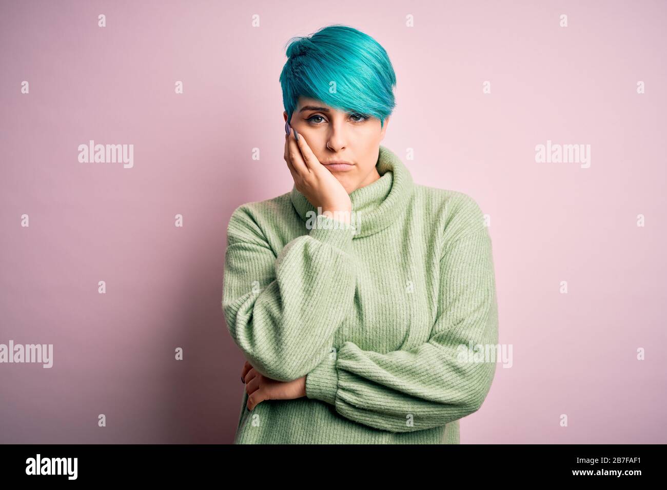 Young beautiful woman with blue fashion hair wearing casual turtleneck ...