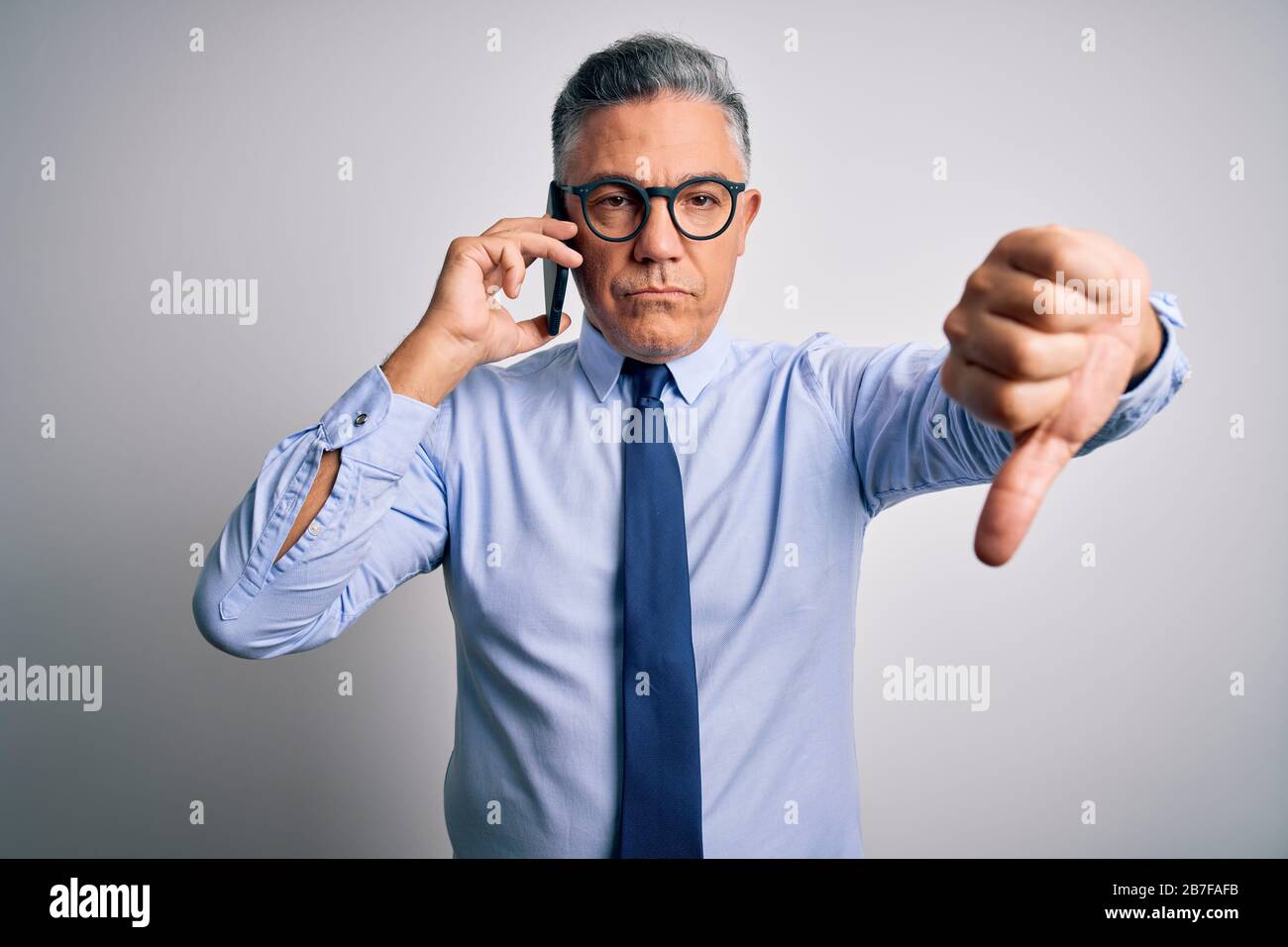 Middle age handsome grey-haired business man having conversation ...