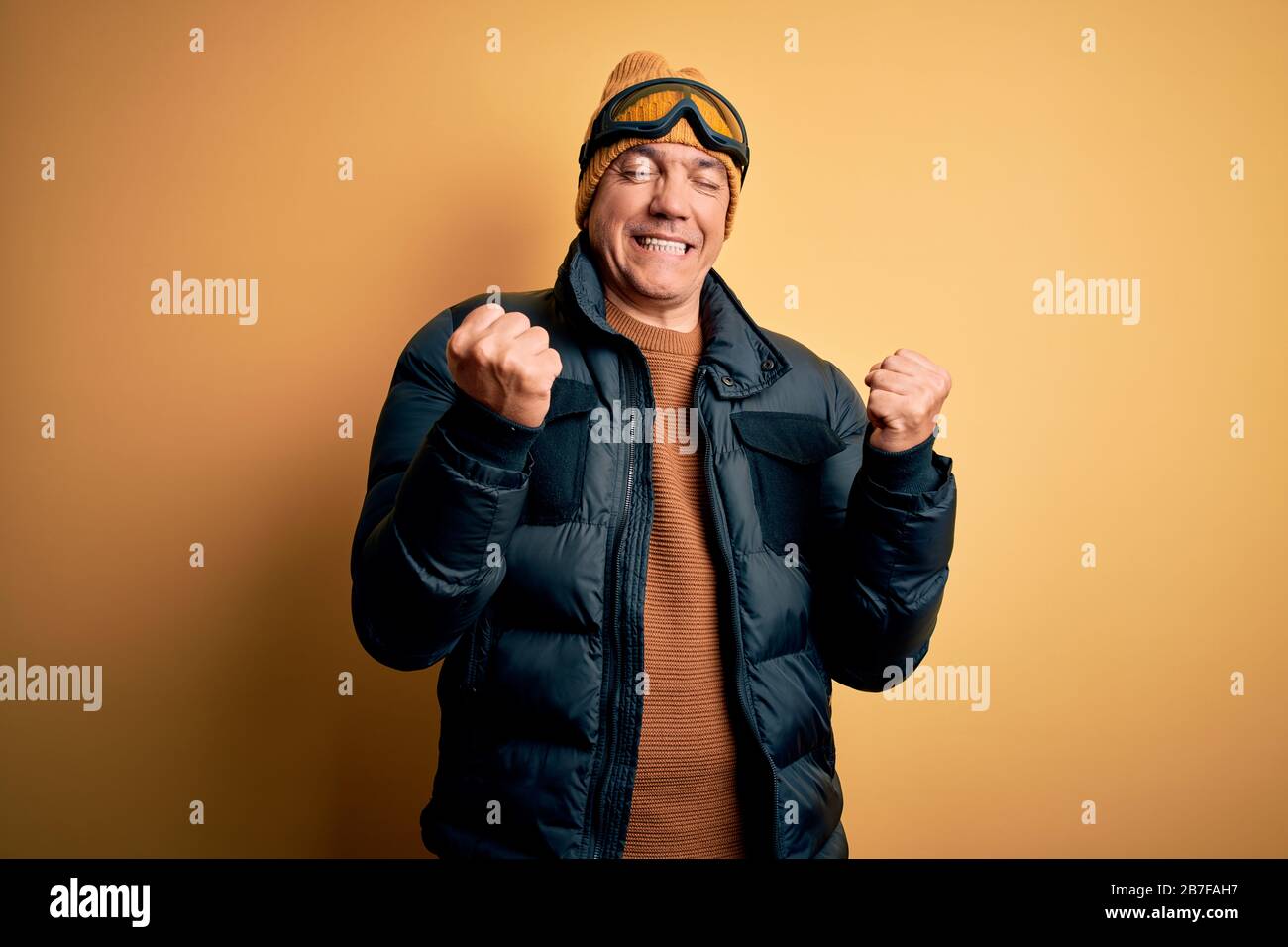 Middle age handsome grey-haired skier man on vacation wearing ski ...
