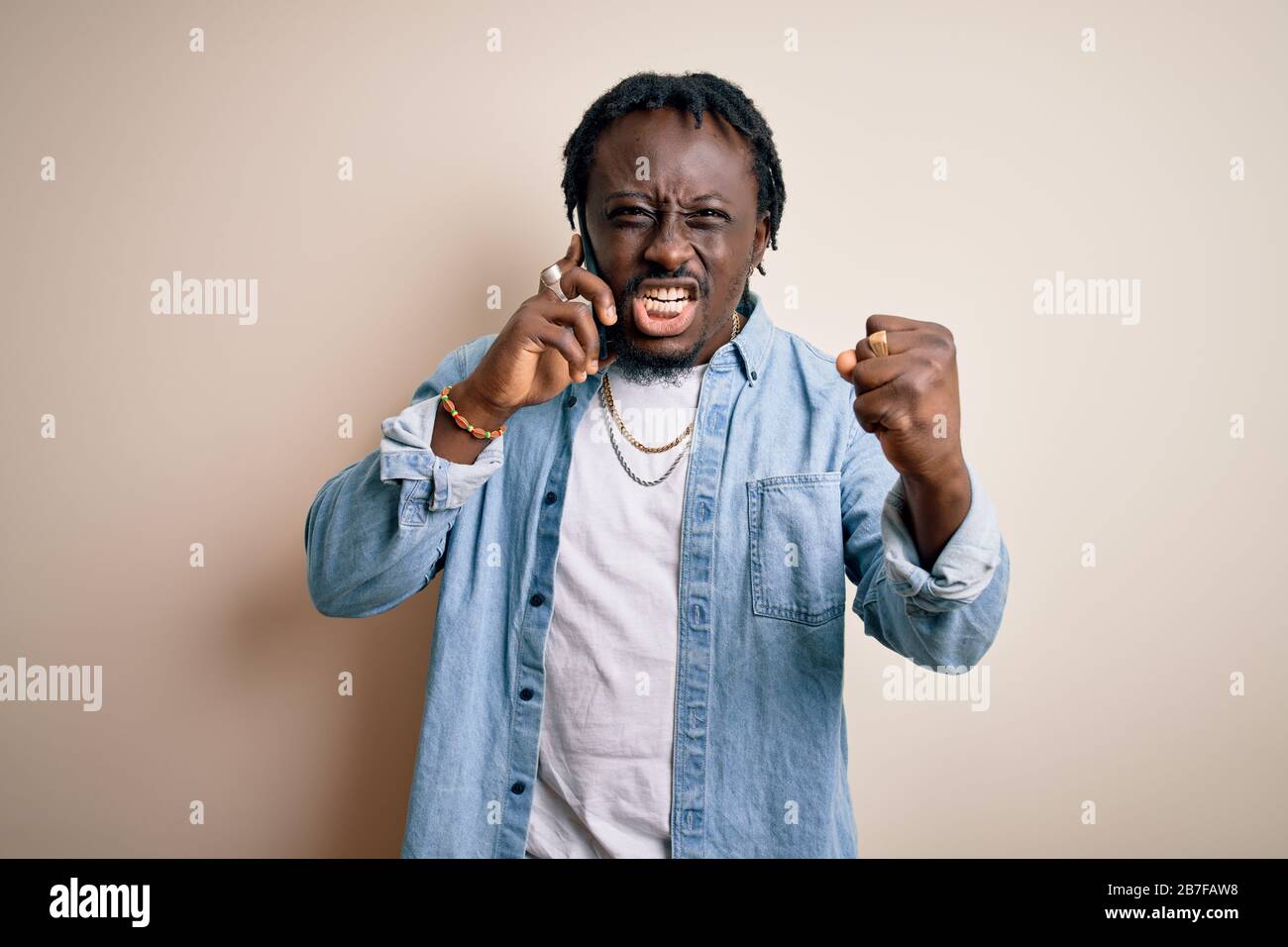 African american man having conversation talking on the smartphone over ...