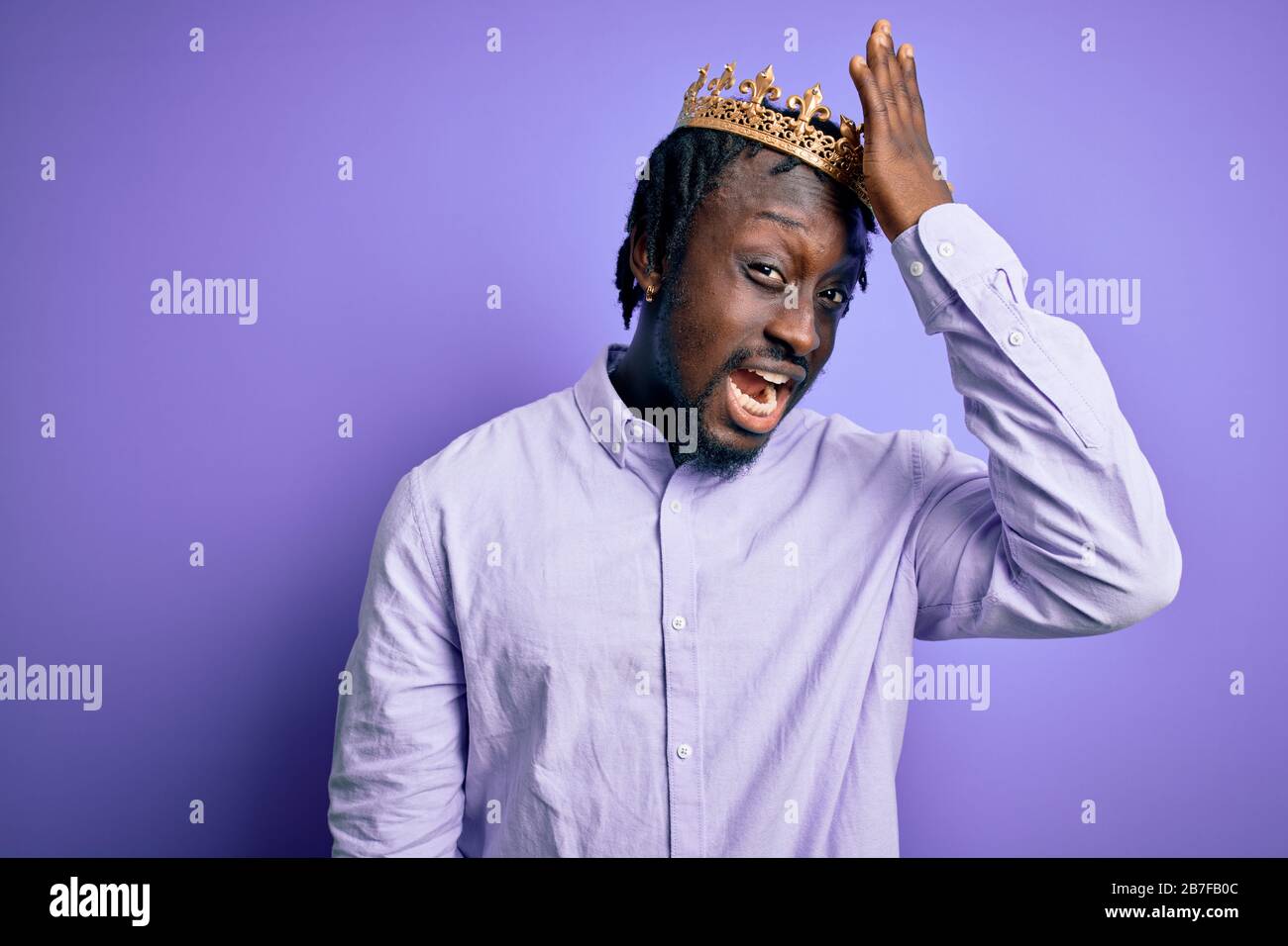 Young african american man wearing golden crown of king over isolated ...