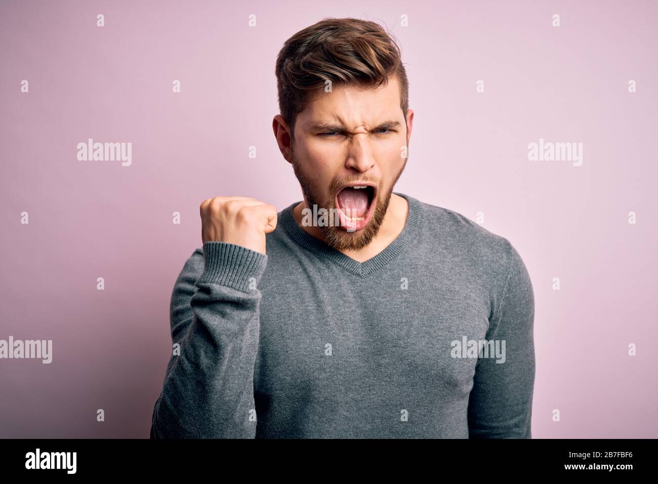 Young handsome blond man with beard and blue eyes wearing casual ...