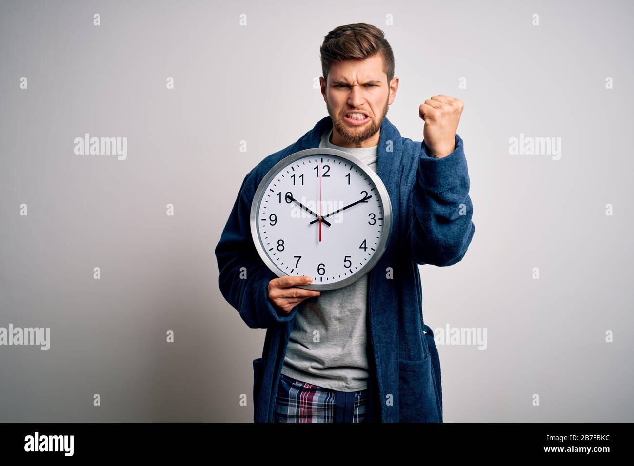 Young blond man with beard and blue eyes wearing pajama holding big ...