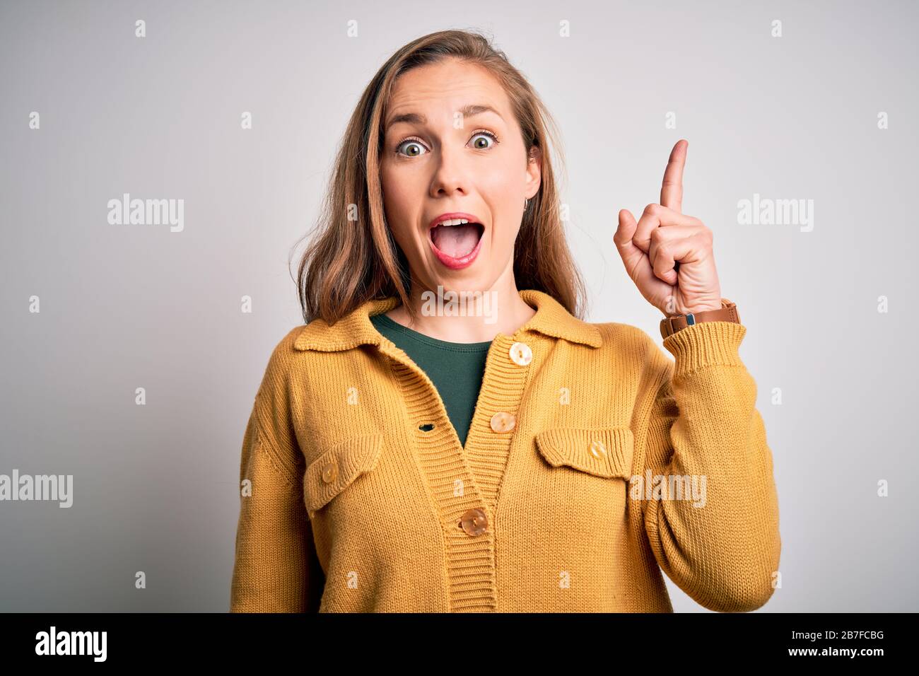 Young Beautiful Blonde Woman Wearing Casual Sweater Over Isolated White Background Pointing