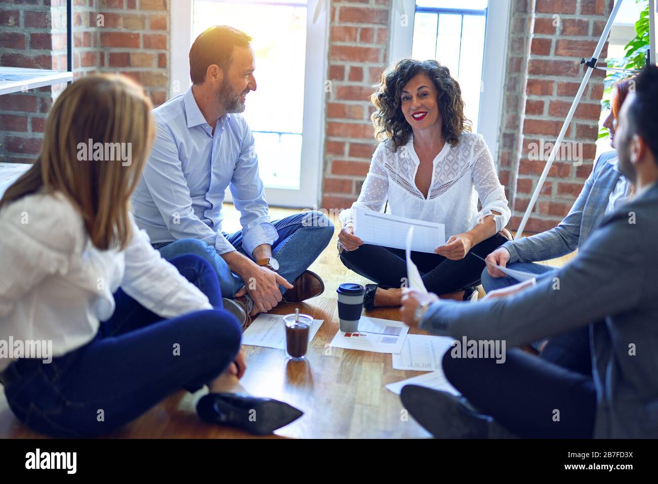 Group of business workers smiling happy and confident. Sitting on the ...