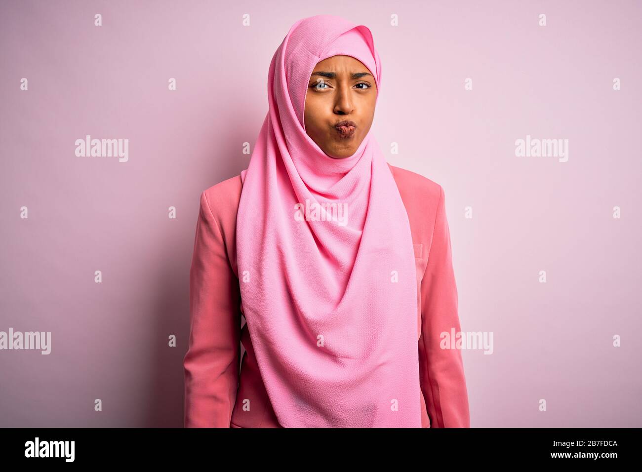 Young African American afro woman wearing muslim hijab over isolated ...