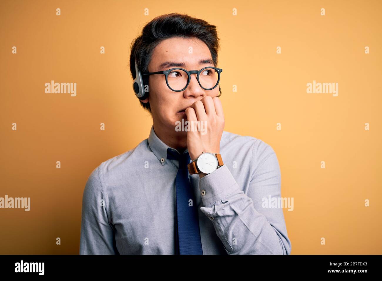 Young handsome chinese call center agent man wering glasses using ...