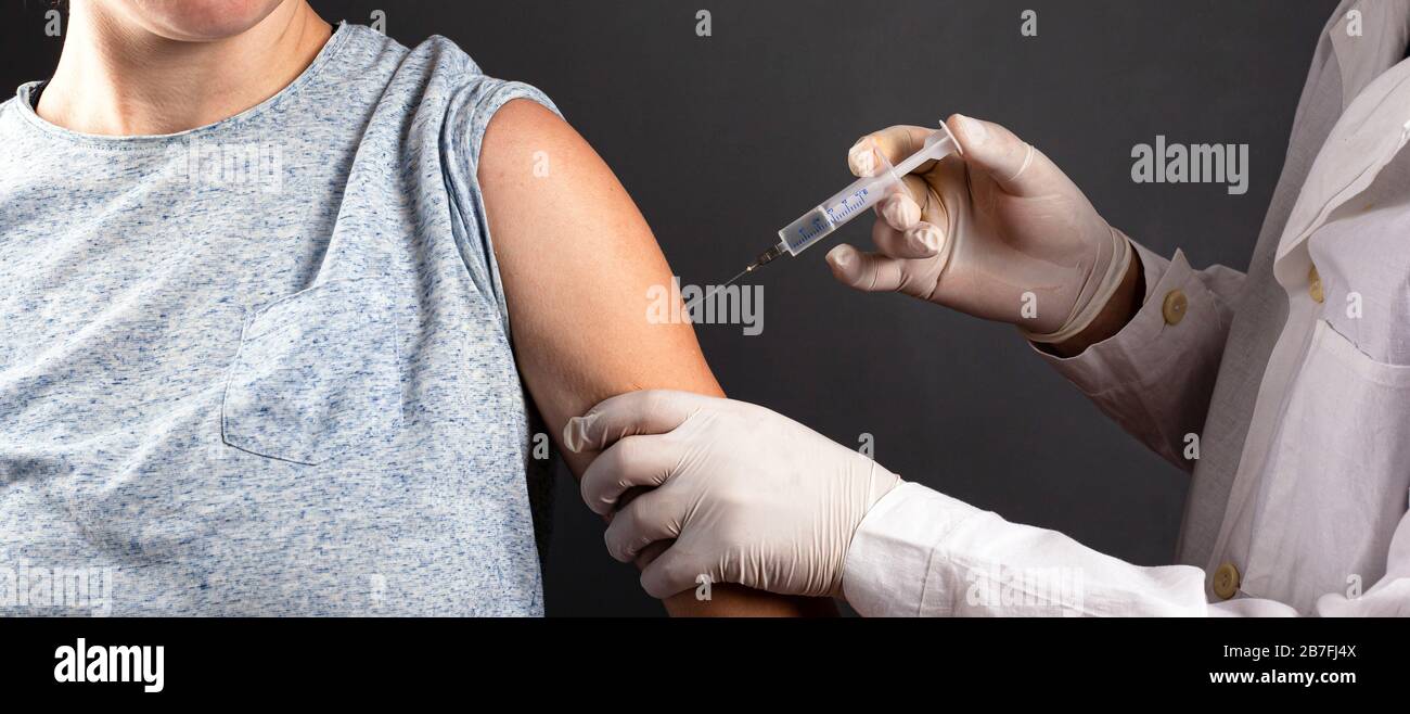 doctor gives an injection to the patient's hand close-up. vaccination ...