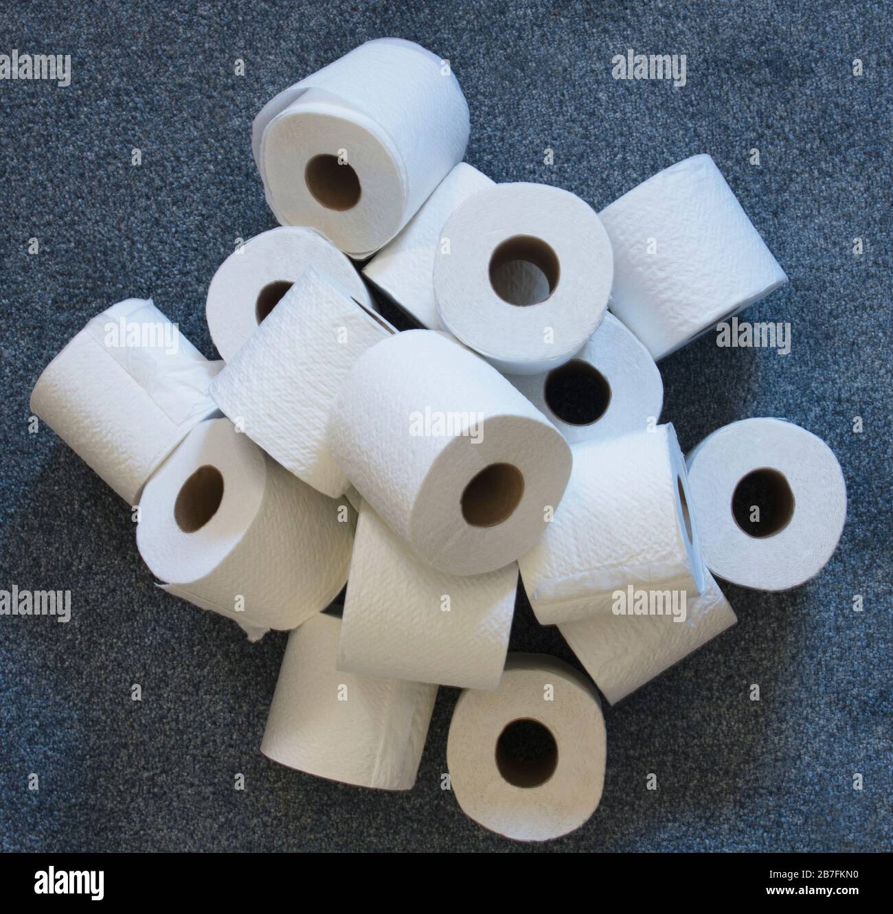 Pile of toilet paper rolls on a blue home carpet from above Stock Photo ...