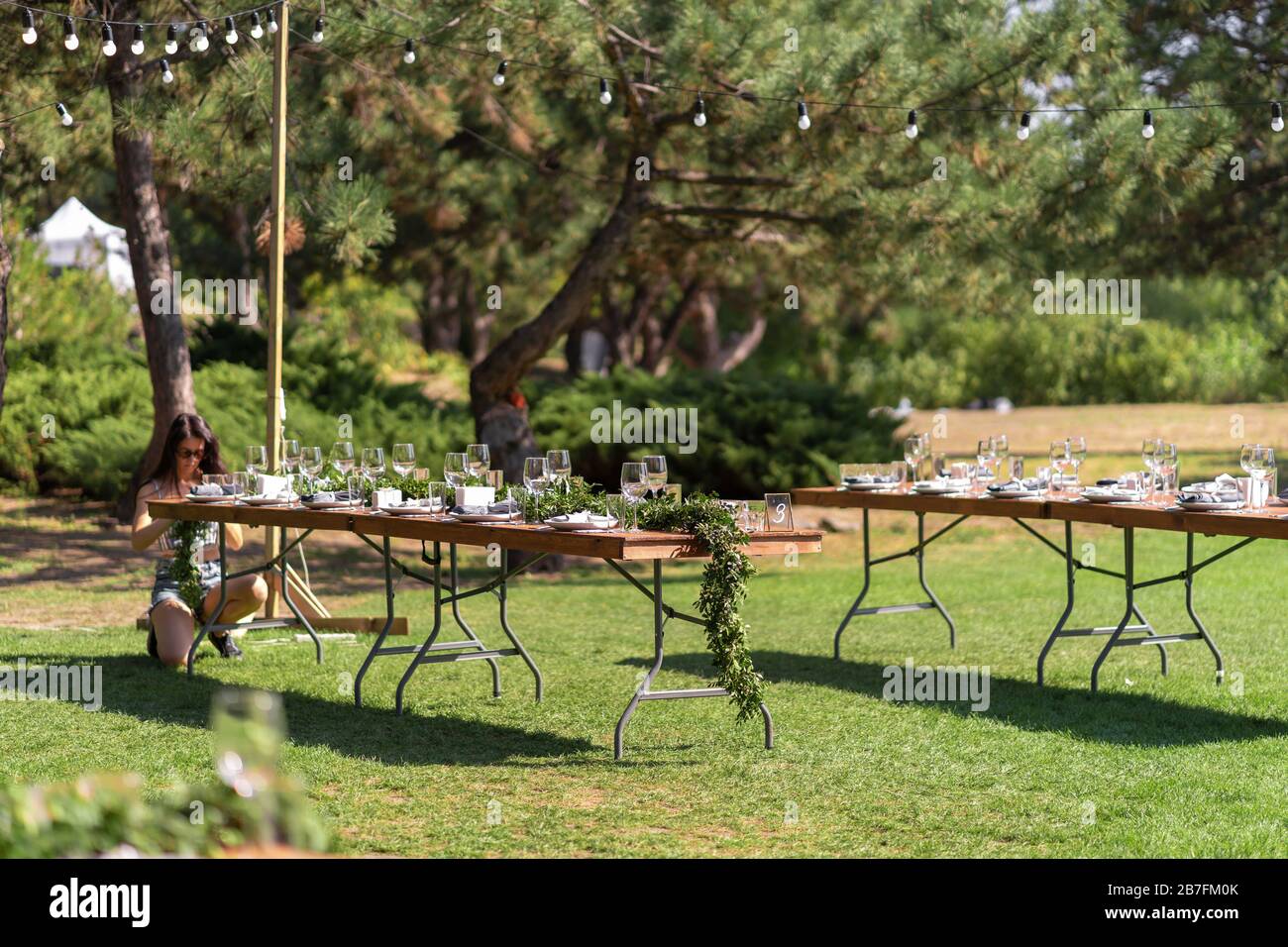 Preparing for an open-air party. Decorated served tables await guests ...