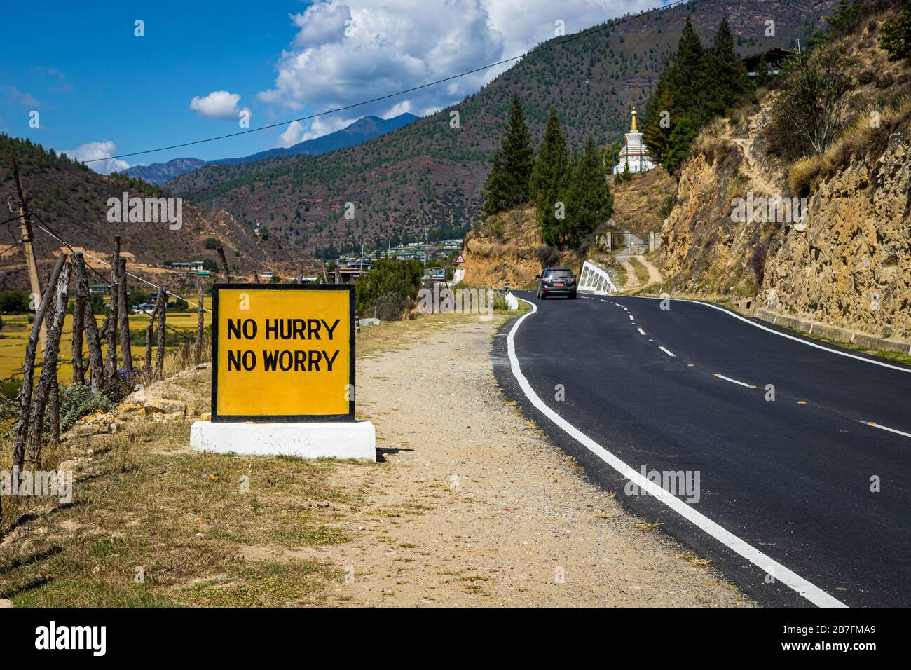 Roadside safety message sign "No Hurry, No Worry" on the Paro-Thimphu ...