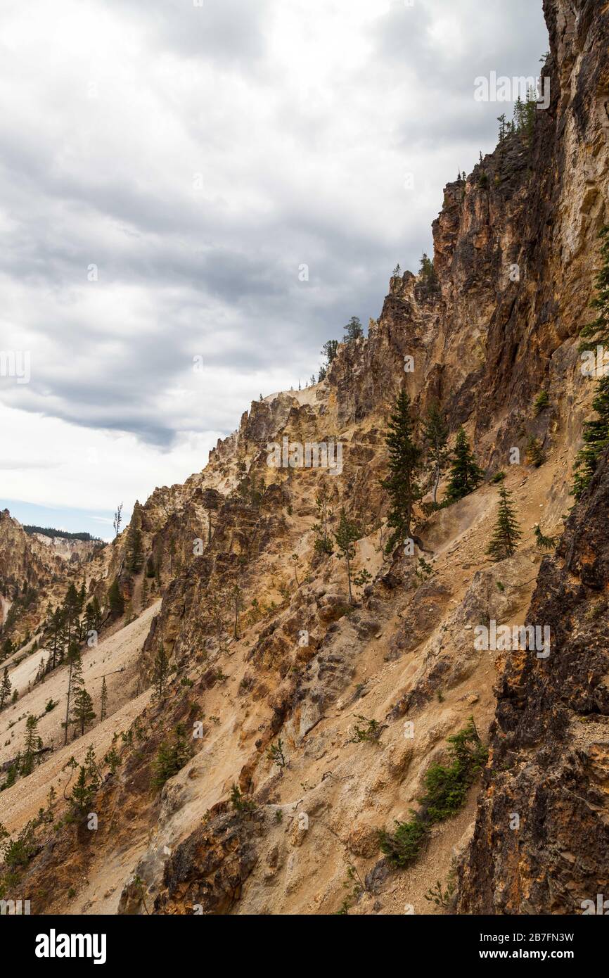 Steep rock walls that have been eroded over time and topped with ...