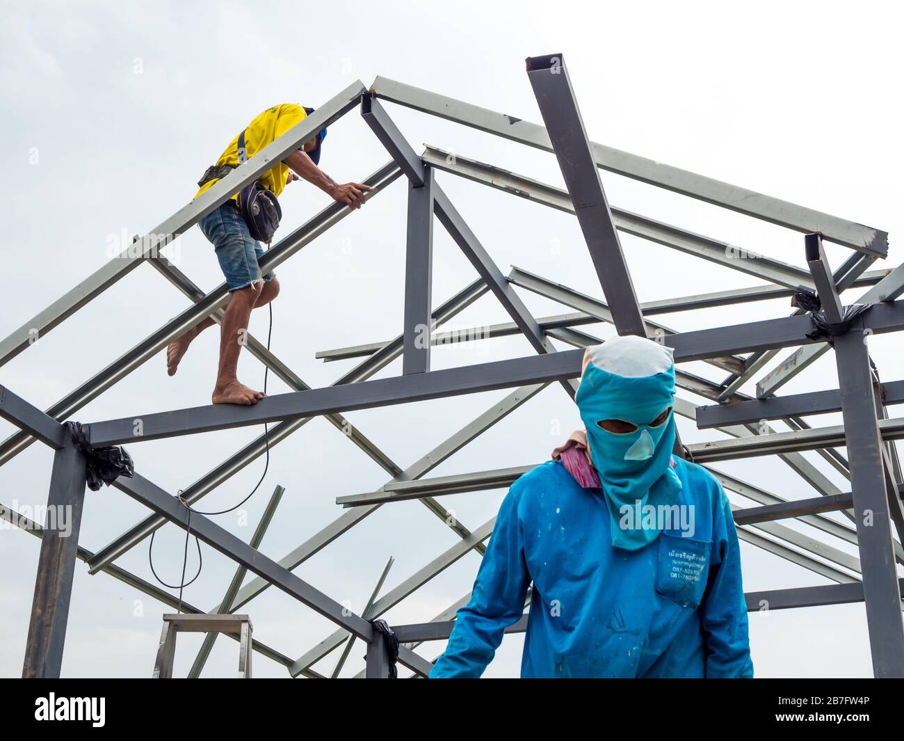 Workers working in the construction site to build a house Stock Photo ...