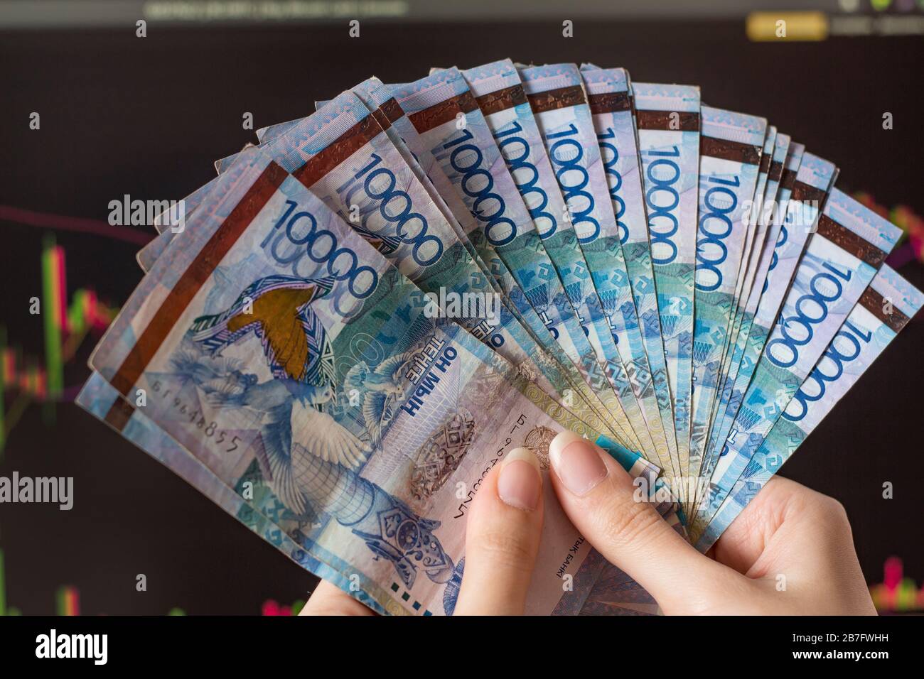 Tenge in Kazakhstan against the background of a laptop with an open ...