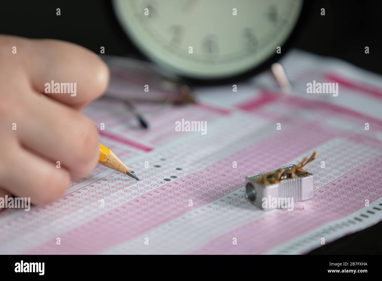 Person filling in a checklist next to a table watch - time management ...