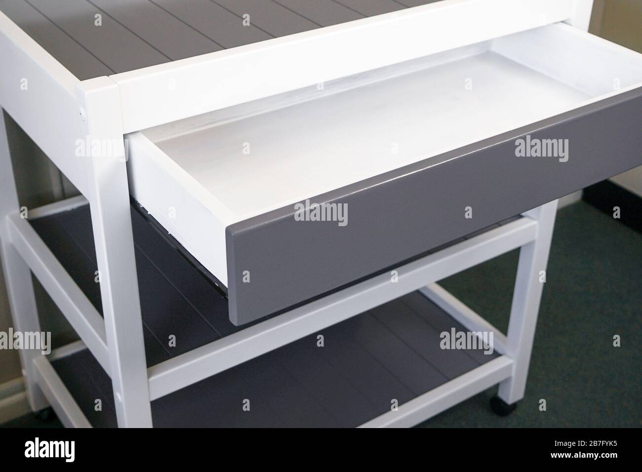 Closeup of a modern white table with a drawer under the lights Stock ...