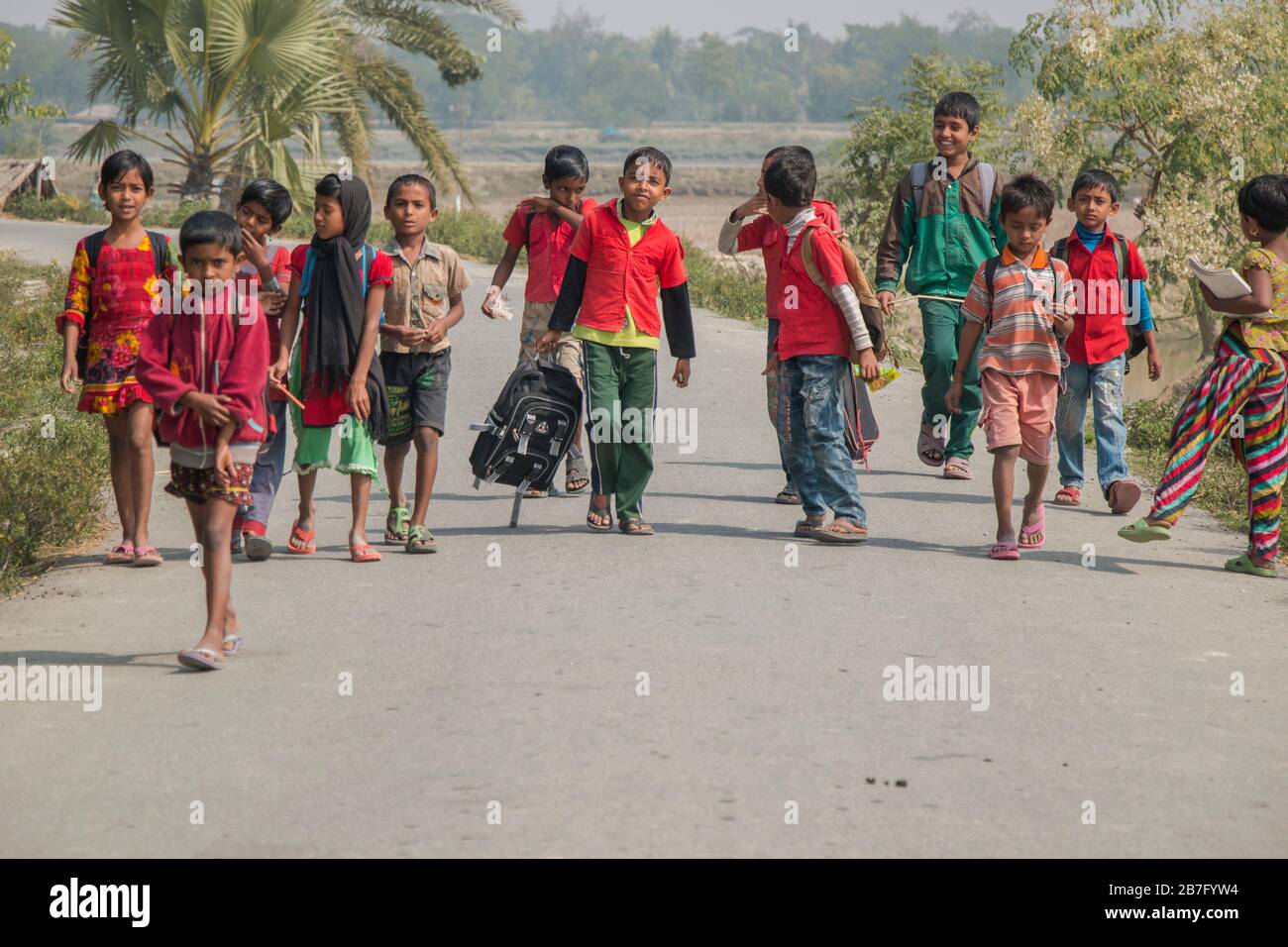Bangladesh school children returning from school and carrying their bag ...