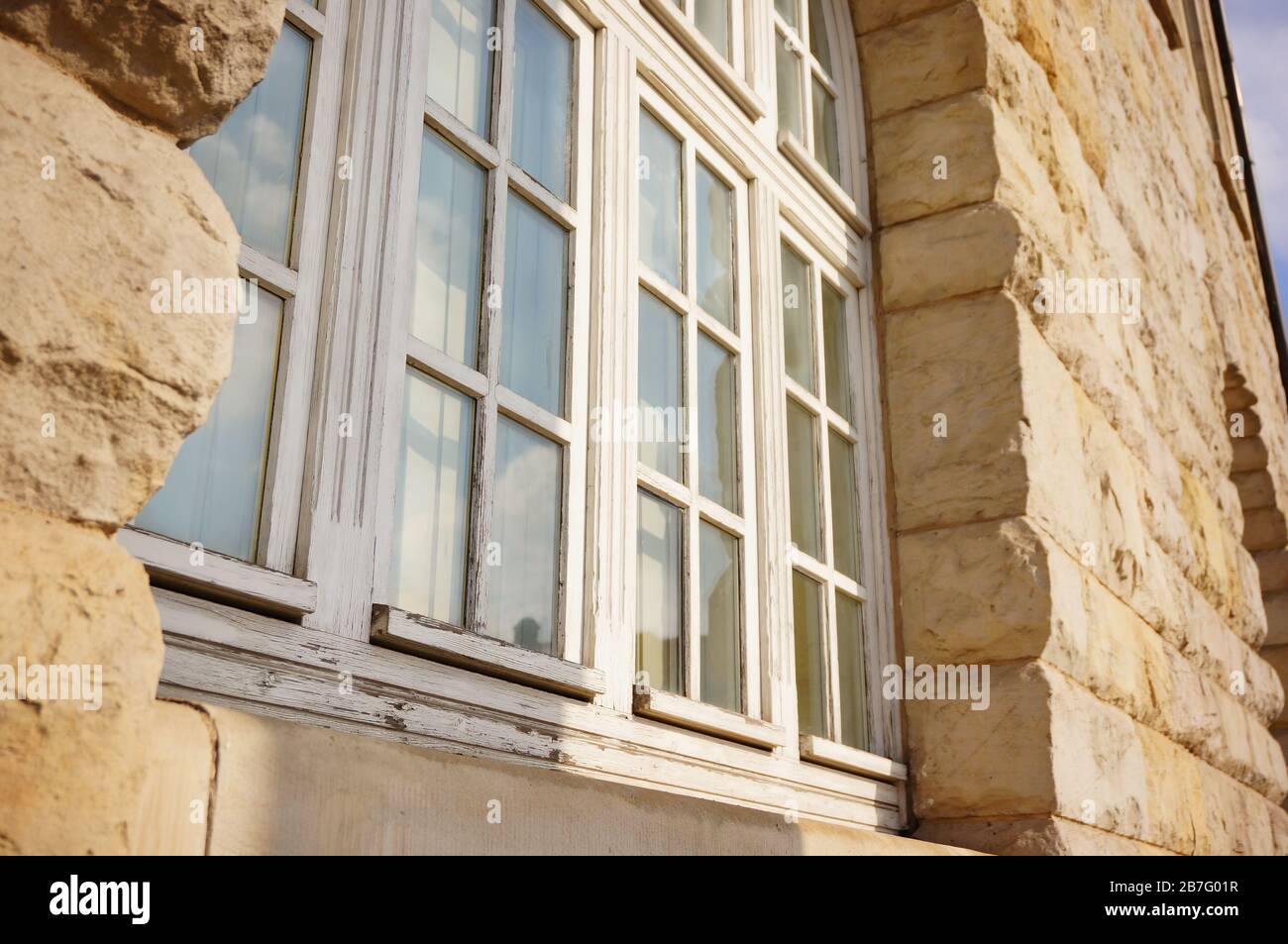 Low angle shot of an old concrete building with reflective windows ...