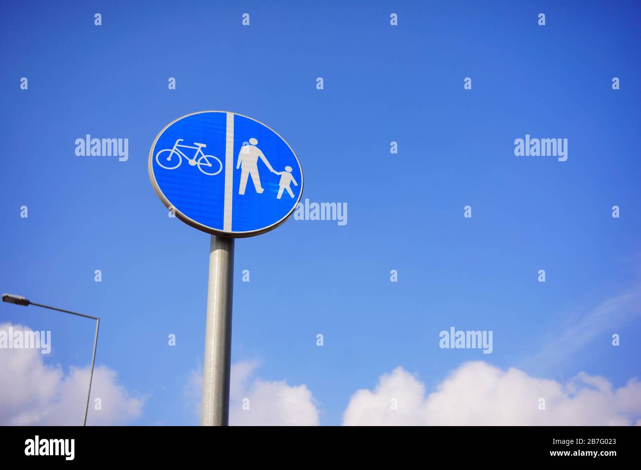 Blue street sign with a bicycle and a child Stock Photo - Alamy