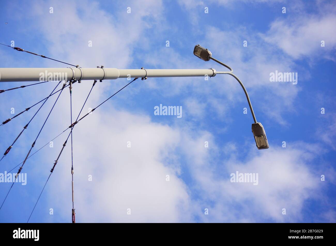 Low angle shot of a street light with a lot of electricity wires Stock ...