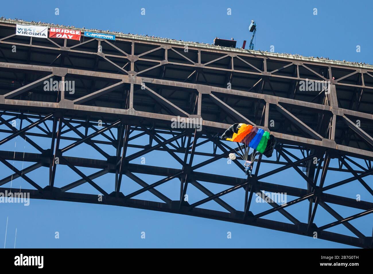A BASE jumper performing a stunt during Bridge Day at New River Gorge ...