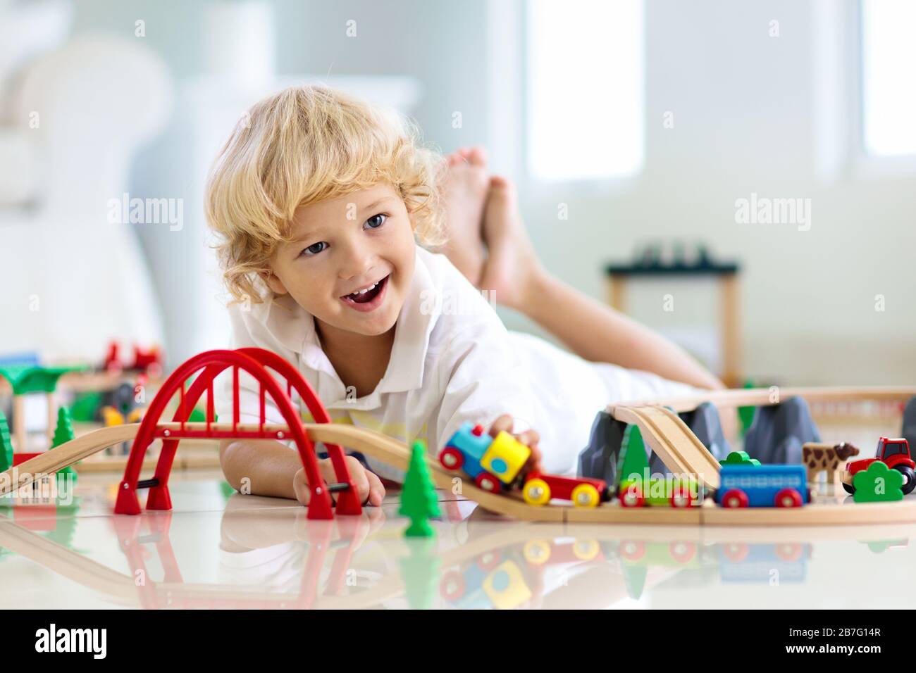 Kids play with wooden railway. Child with toy train. Educational toys ...